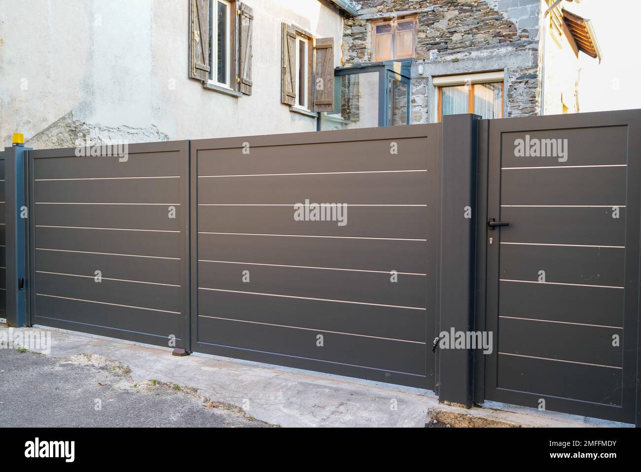Aluminum dark brown gate of home portal of suburb house Stock Photo - Alamy