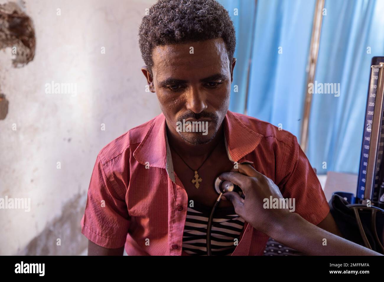 A Tigrinyan man gets a medical checkup inside the Mercy Corps clinic at ...
