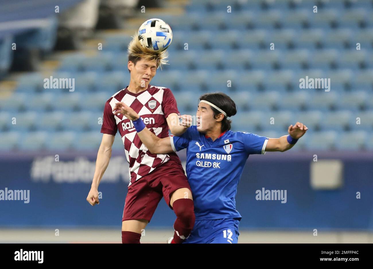 Vissel Kobe's Ryuho Kikuchi, left, heads the ball past Suwon Samsung ...