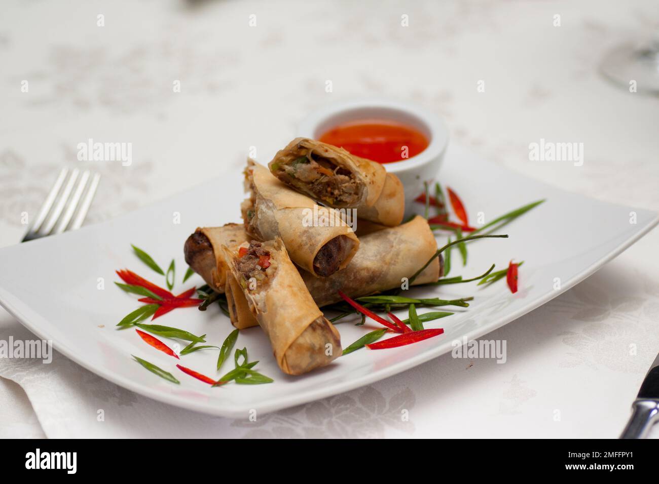 Asian style crunchy spring rolls with hot sauce Stock Photo - Alamy