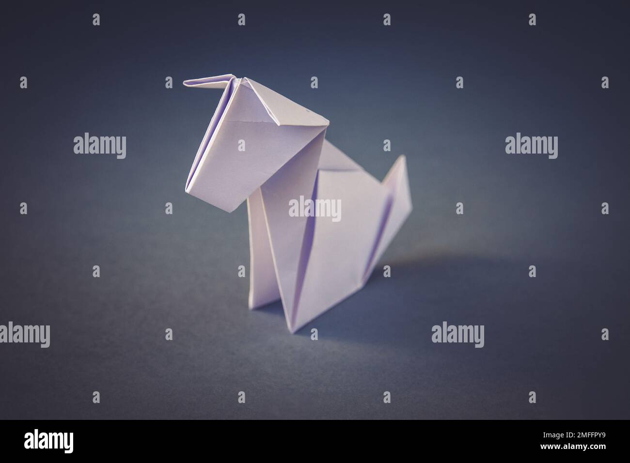 White paper dog origami isolated on a blank grey background Stock Photo ...