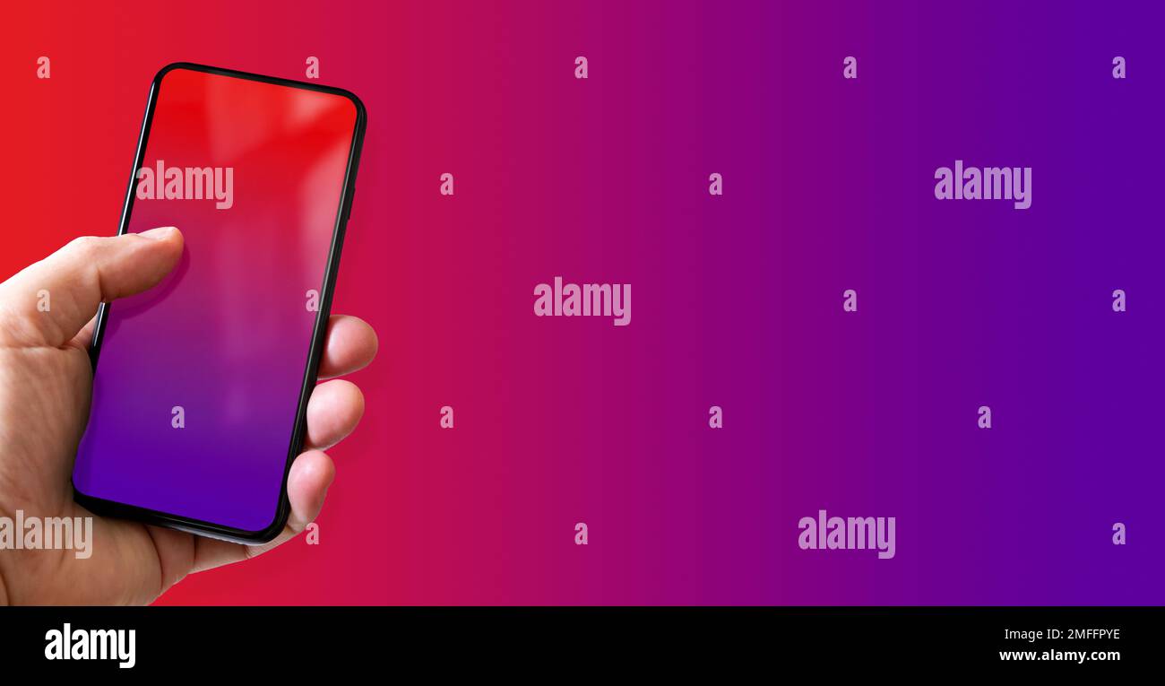 Hand holding a smartphone with blank red and purple screen. Colorful ...