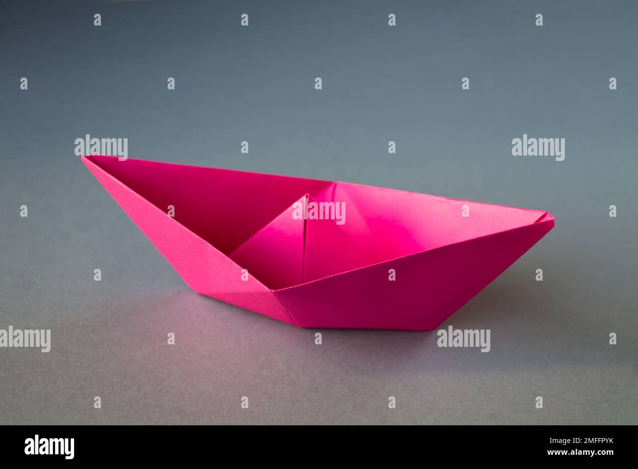 Pink paper boat origami isolated on a blank grey background Stock Photo ...
