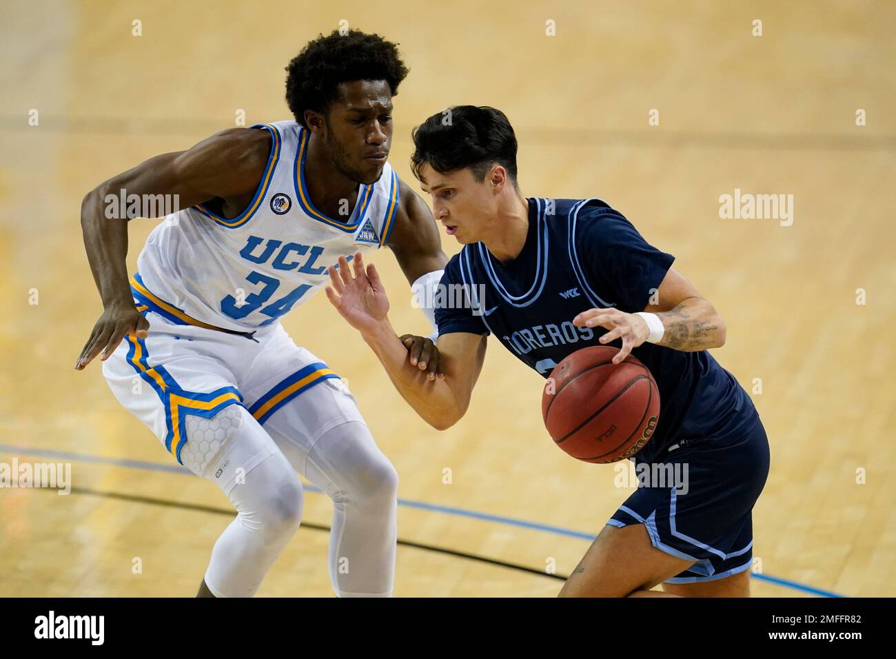 UCLA guard David Singleton, left, defends against San Diego guard Chris ...