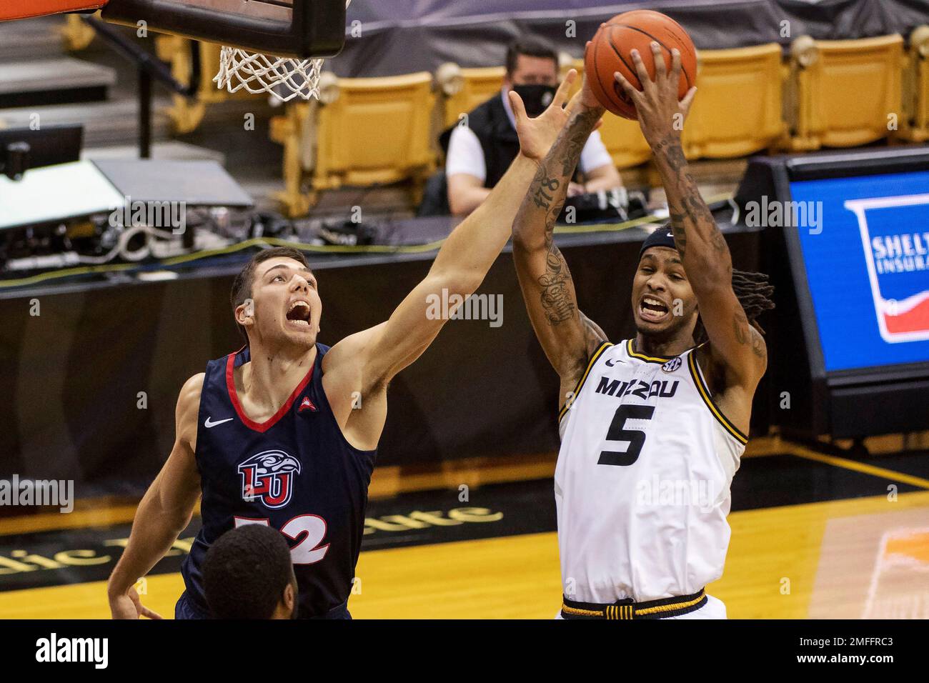Missouri's Mitchell Smith, right, pulls down a rebound next to Liberty ...