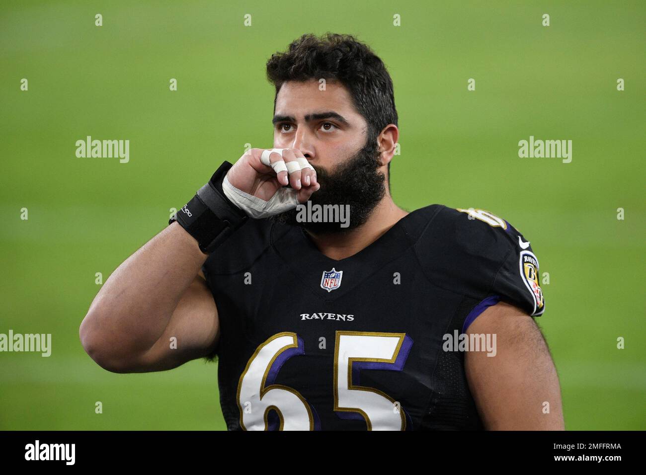 Baltimore Ravens offensive guard Patrick Mekari (65) pauses before an ...