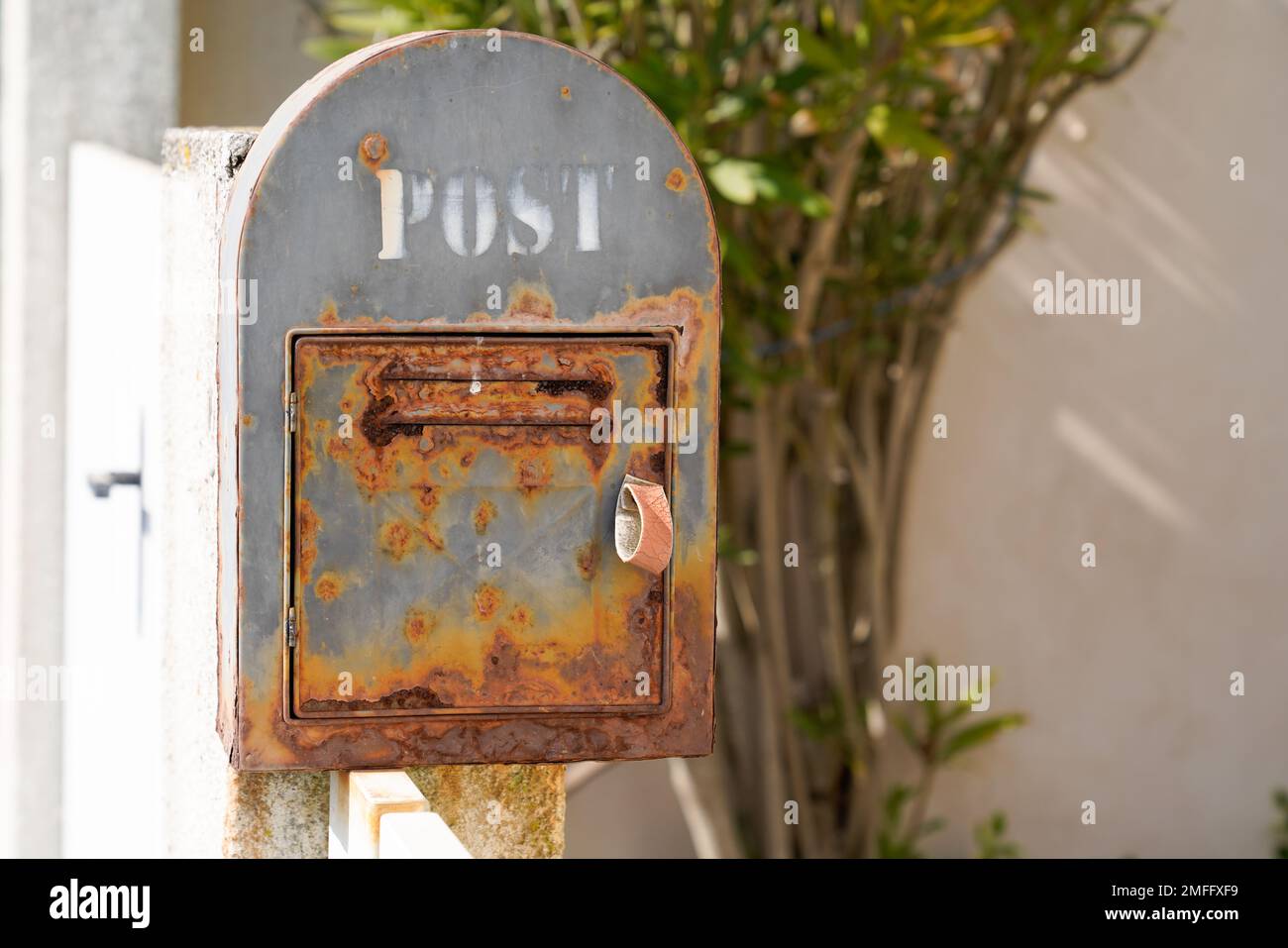 post text sign on an old private mailbox of an old and rusty house ...