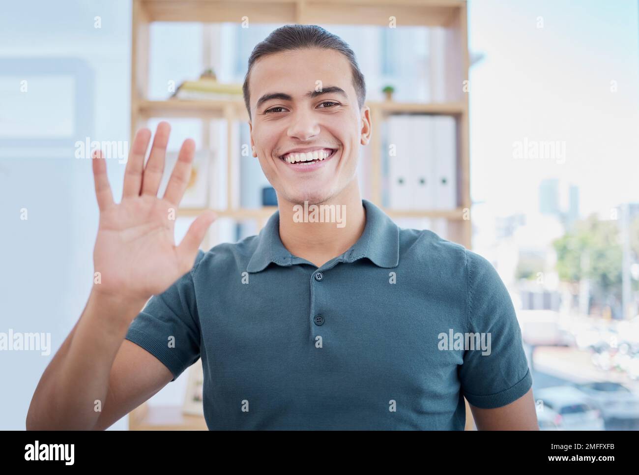 Wave, greeting and portrait of a man in the office for an online ...