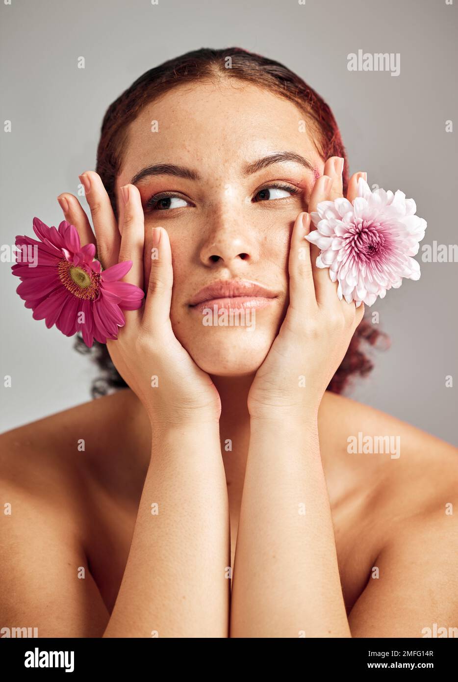 Woman, studio and face with flowers for thinking, beauty or healthy ...
