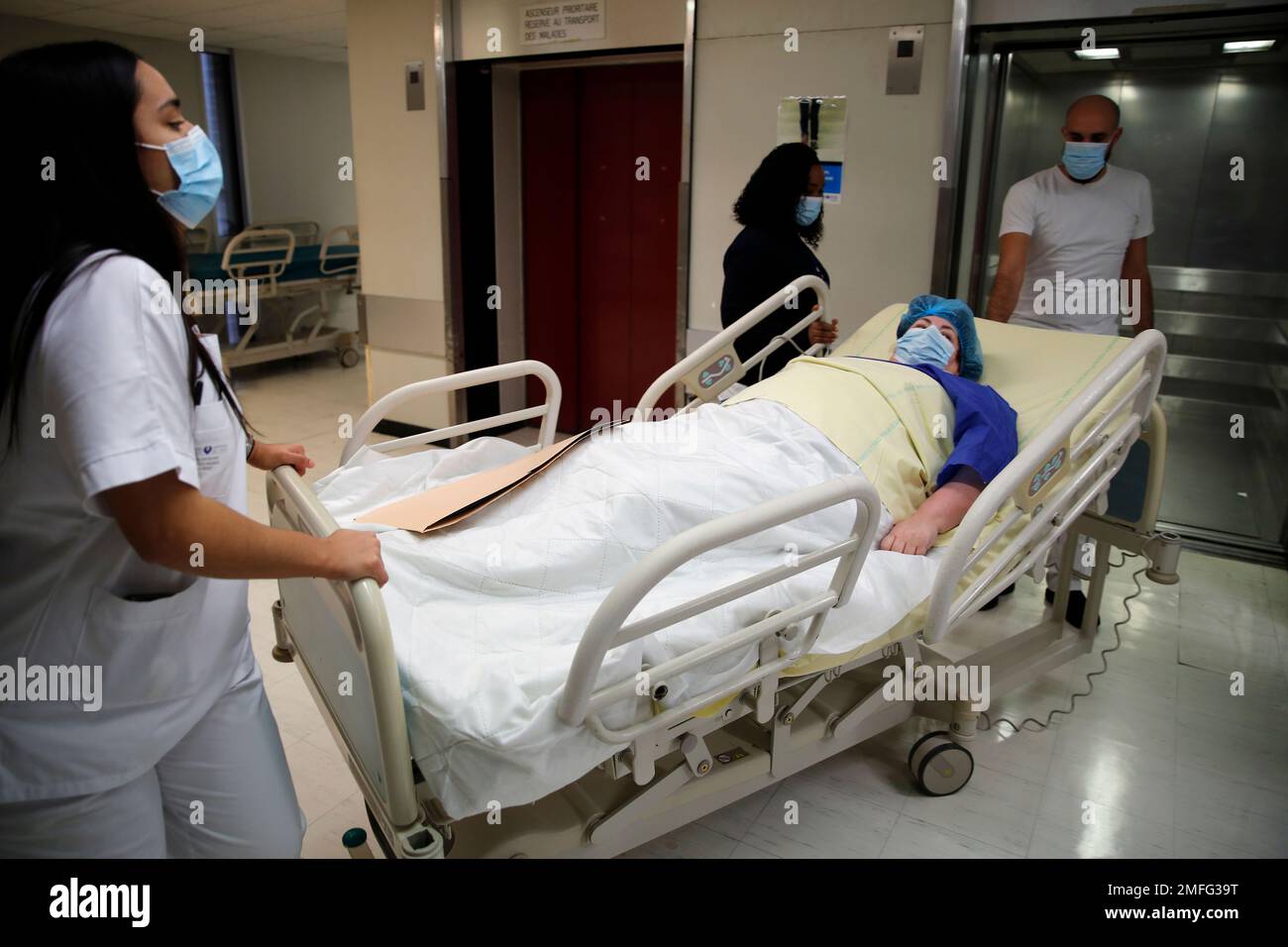 Caroline Erganian, a retired secretary, is moved on a gurney for her ...