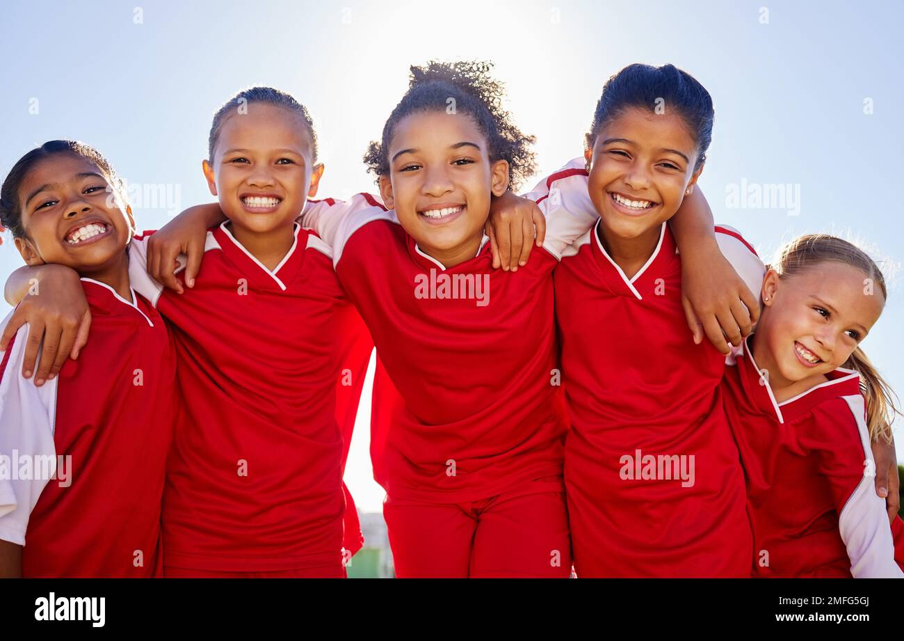 Group portrait, girl football and field with smile, team building ...