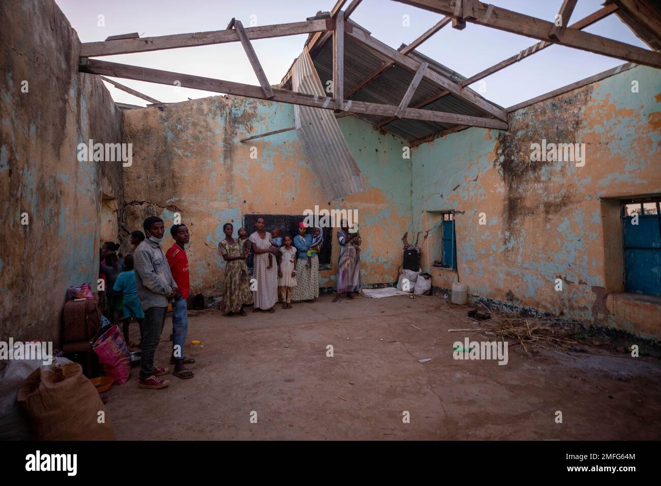 A family who fled the conflict in Ethiopia's Tigray region stand inside ...