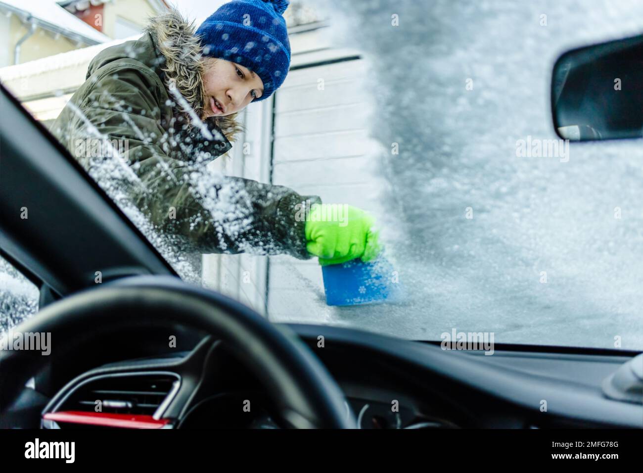 Ice scraping cleans frozen windshield hi-res stock photography and ...