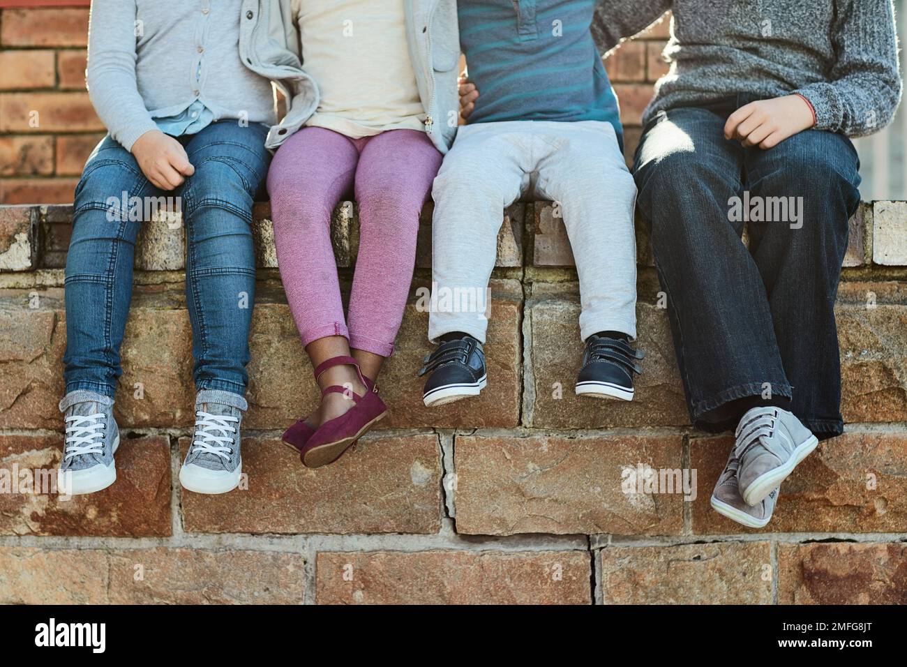 Stay in school. unrecognizable elementary school kids sitting on a ...
