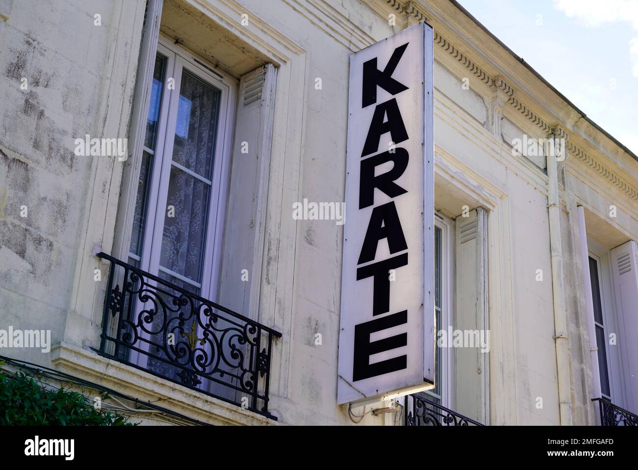 Karate sign text above a dojo wall building Stock Photo - Alamy