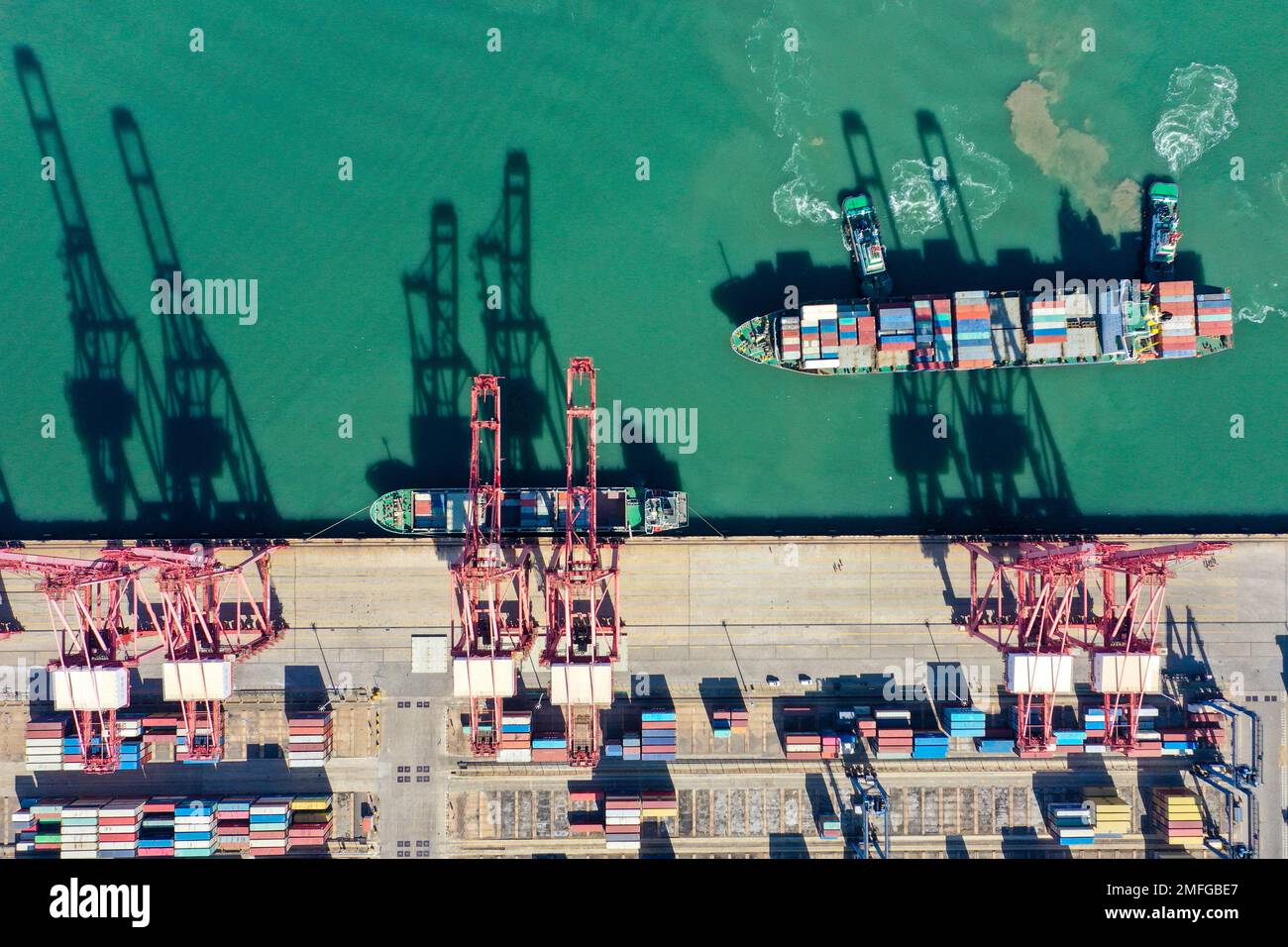 LIANYUNGANG, CHINA - JANUARY 25, 2023 - Cargo ships are loaded with ...