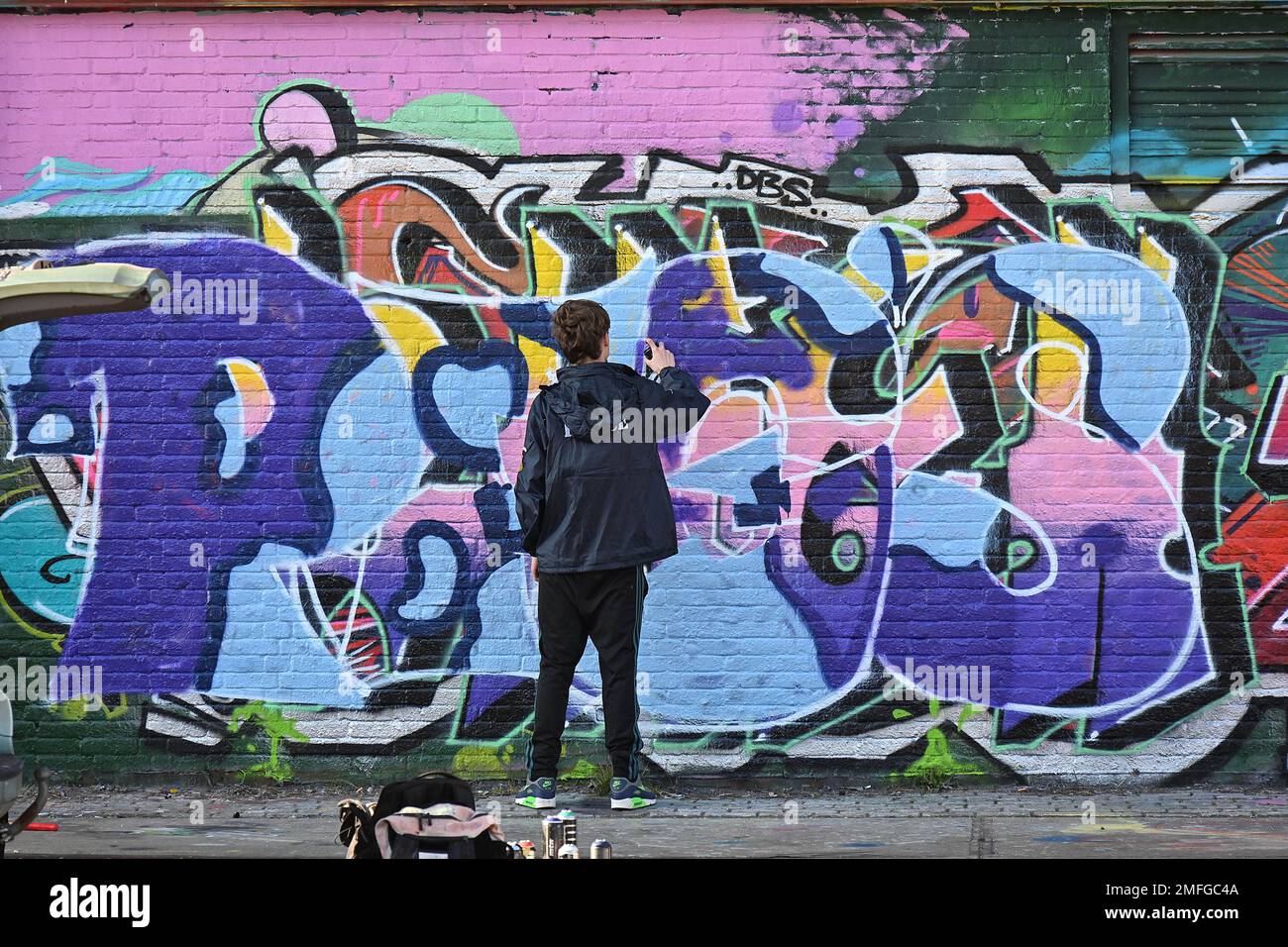The Netherlands, Amsterdam: street artists at work, realizing colorful ...