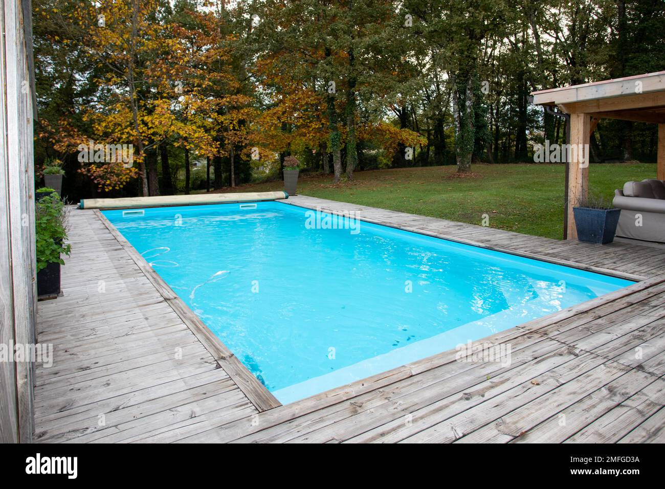 wooden corner of swimming pool with blue water Stock Photo - Alamy
