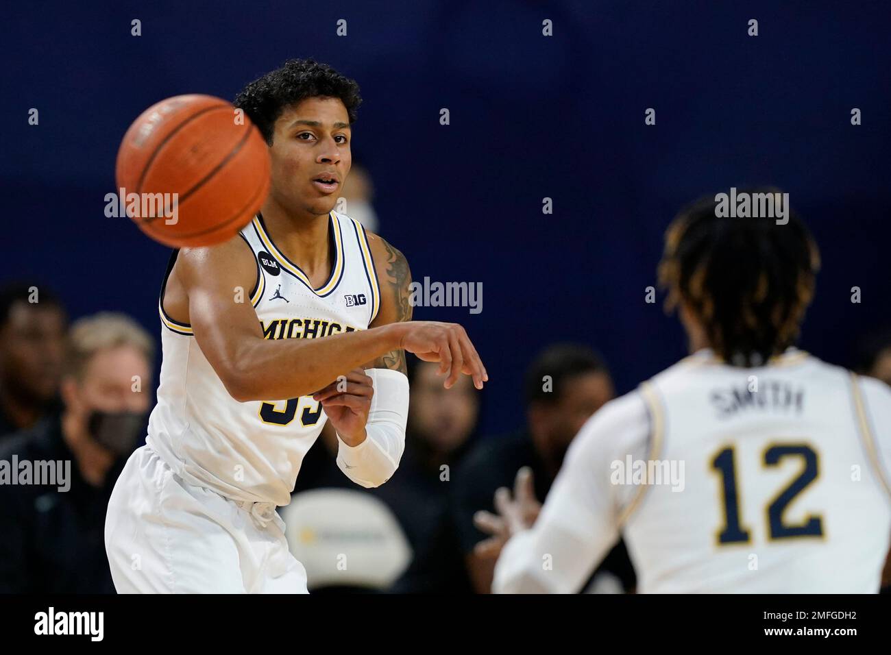 Michigan guard Eli Brooks passes to guard Mike Smith (12) during the ...