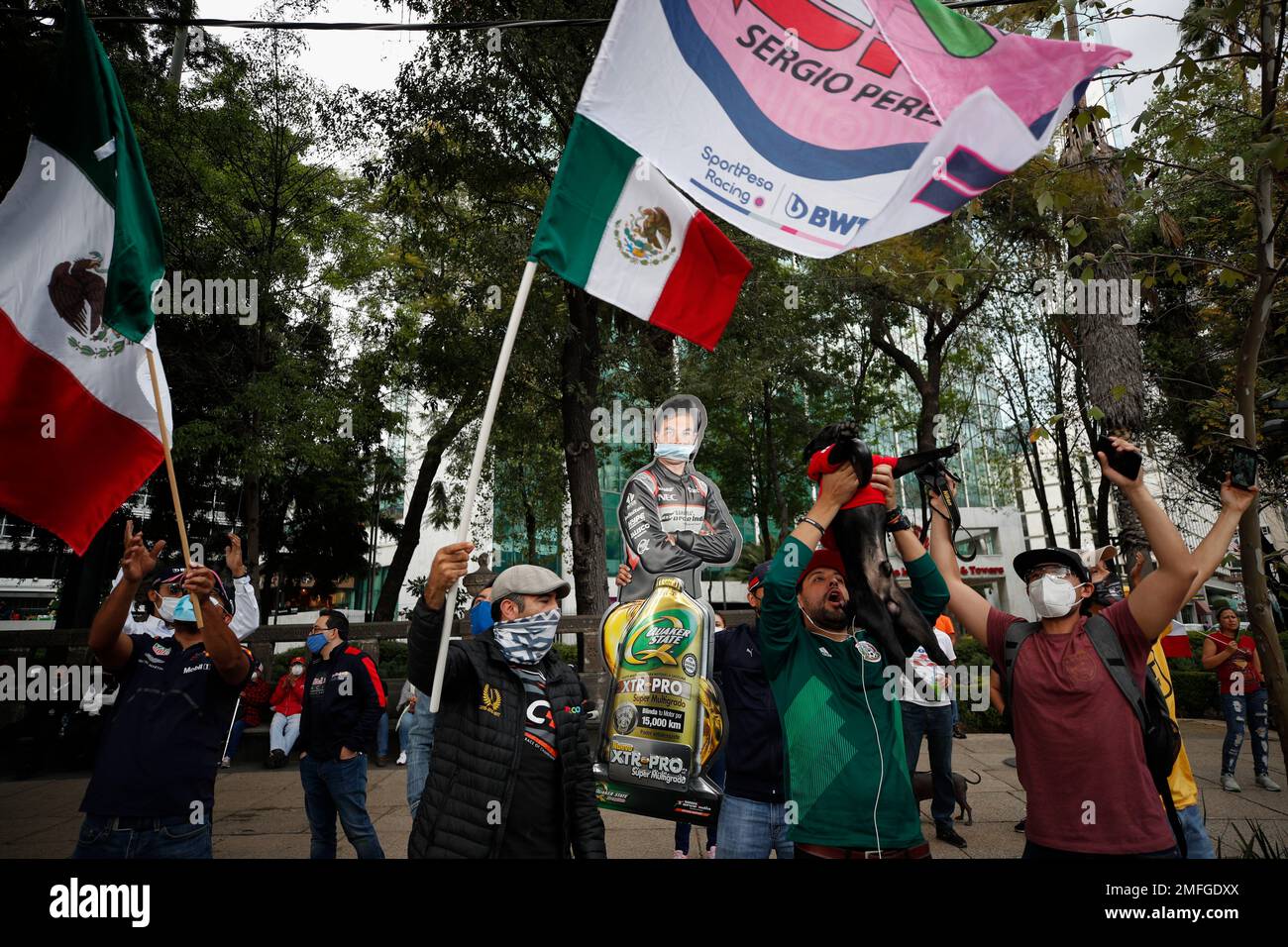 Fans wave flags and hold up a promotional cardboard cutout of Sergio ...
