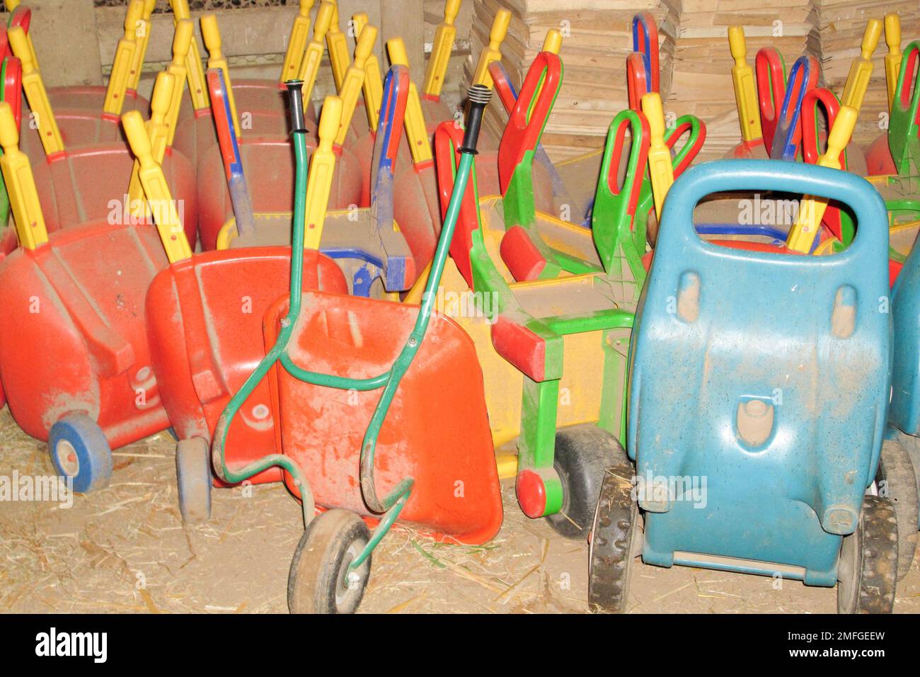 local with several color plastic wheelbarrows for children Stock Photo ...