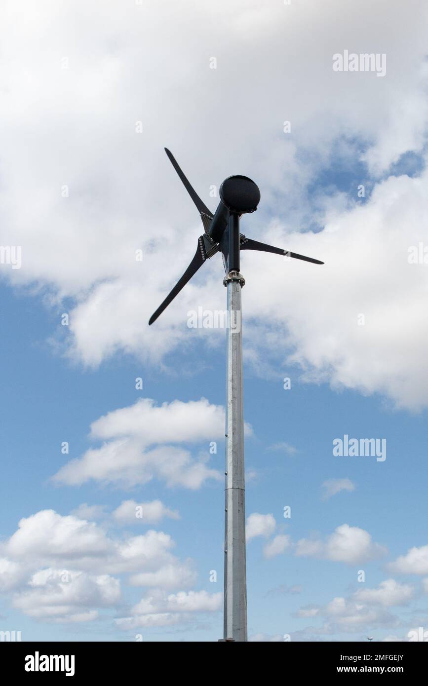 Small wind turbine renewable energy source of future on blue sky with ...