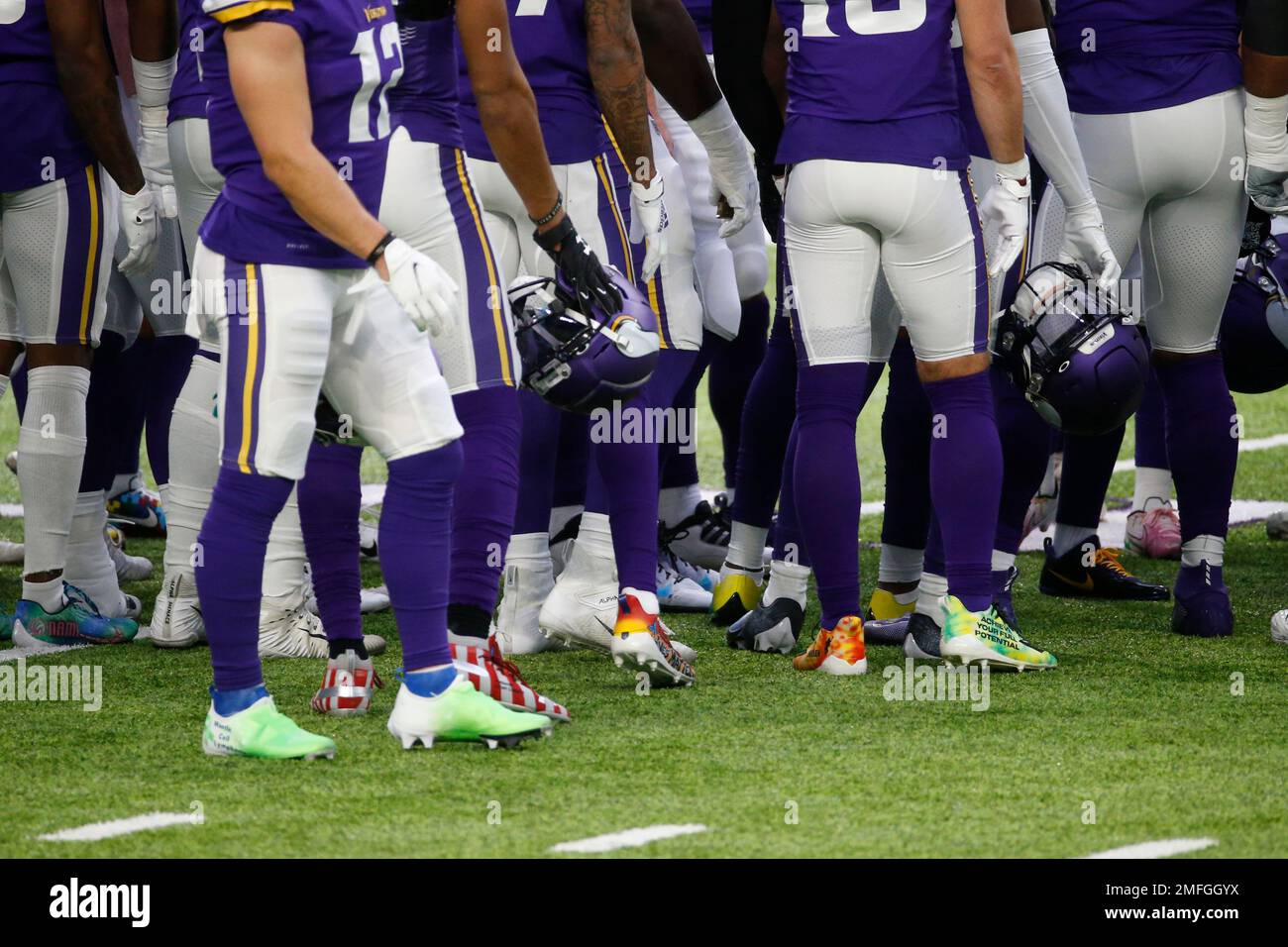 Minnesota Vikings players huddle on the field before an NFL football ...