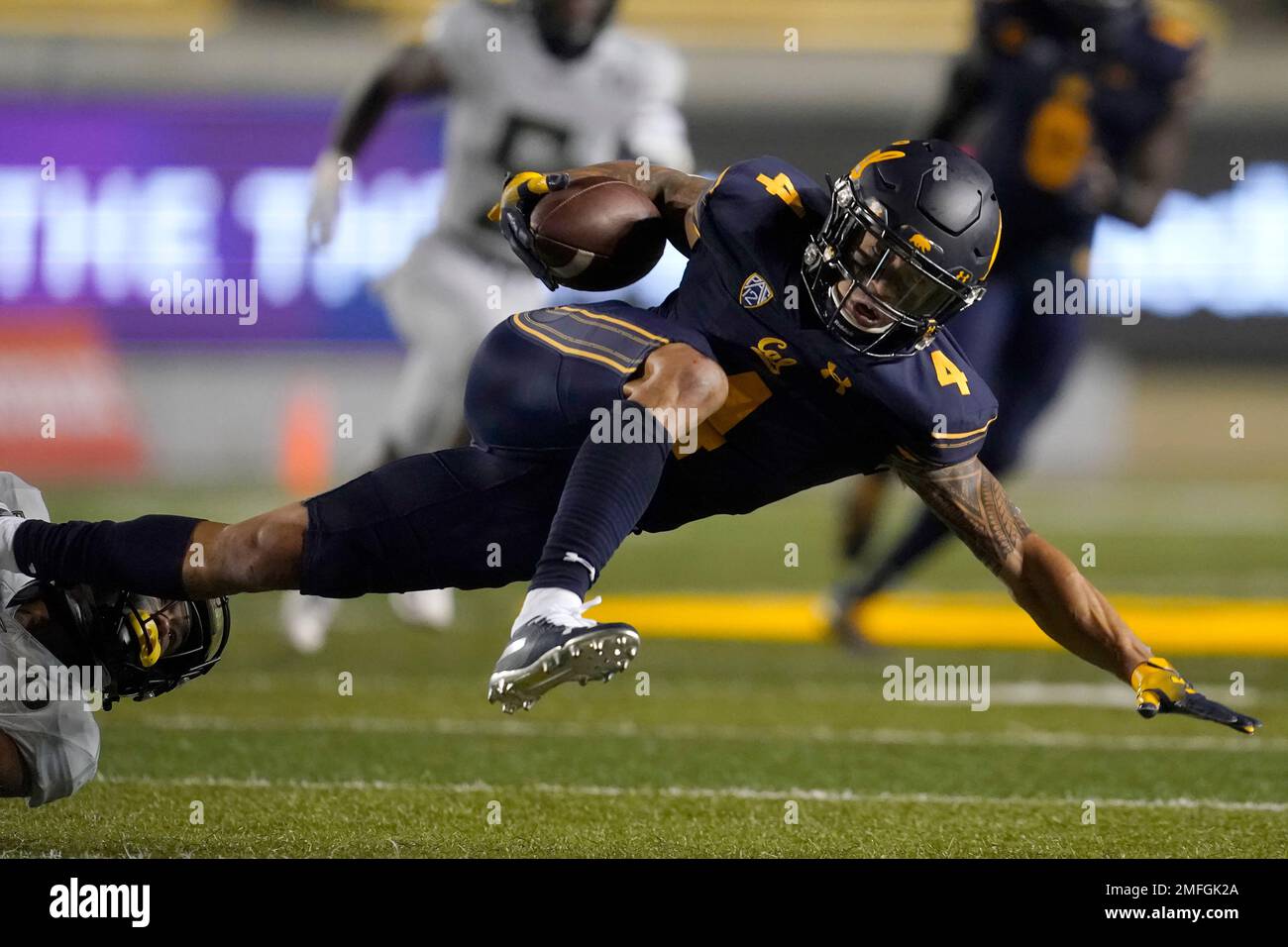 California's Nikko Remigio is tackled on a punt return during the ...