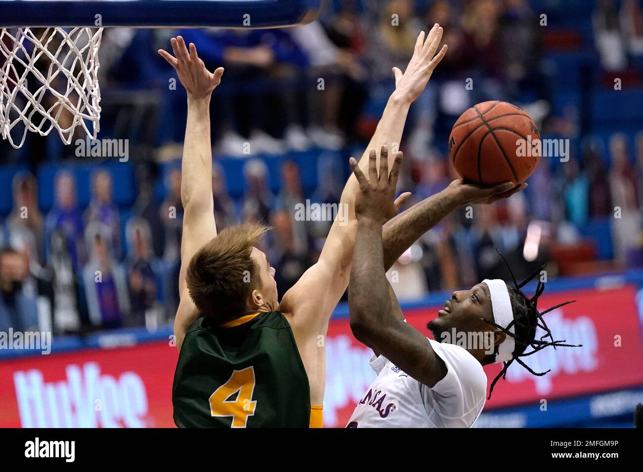 Kansas' Marcus Garrett, right, shoots under pressure from North Dakota ...