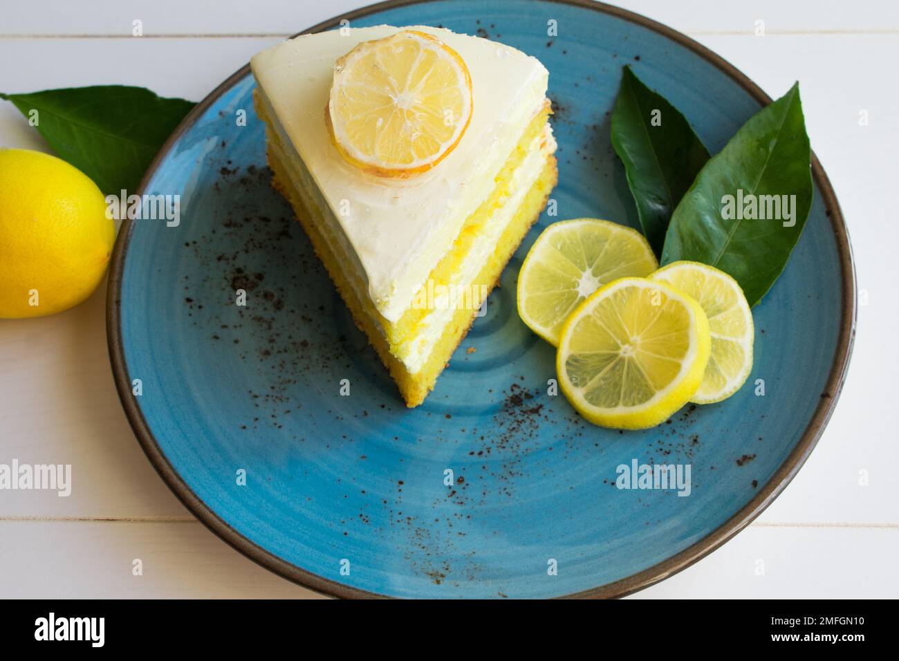 A piece of lemon cream cake on a plate, presentation of delicious ...