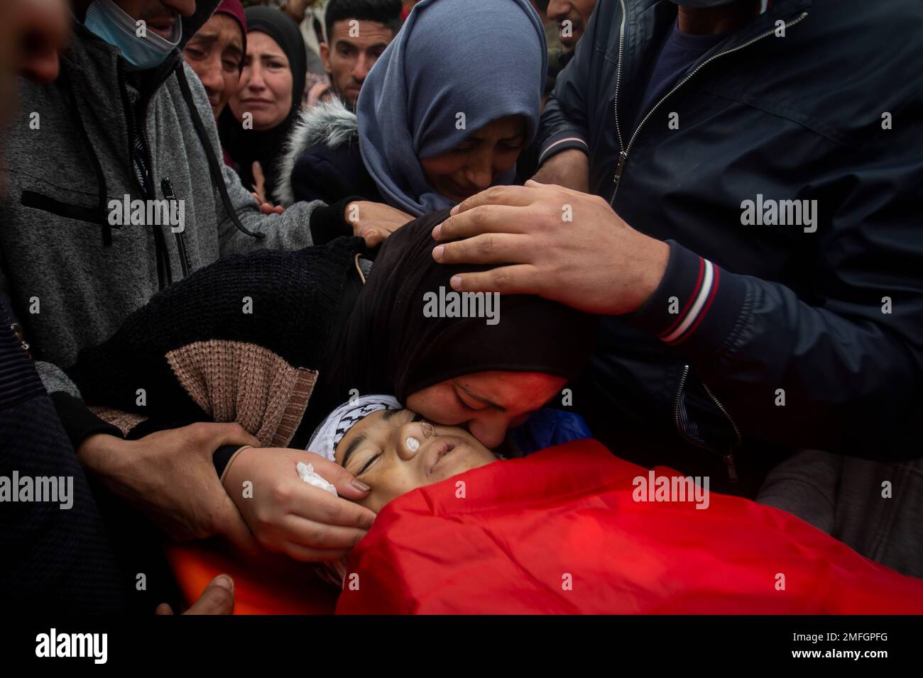 Relatives mourn the body of a 13-year-old Ali Abu Alia who was shot ...