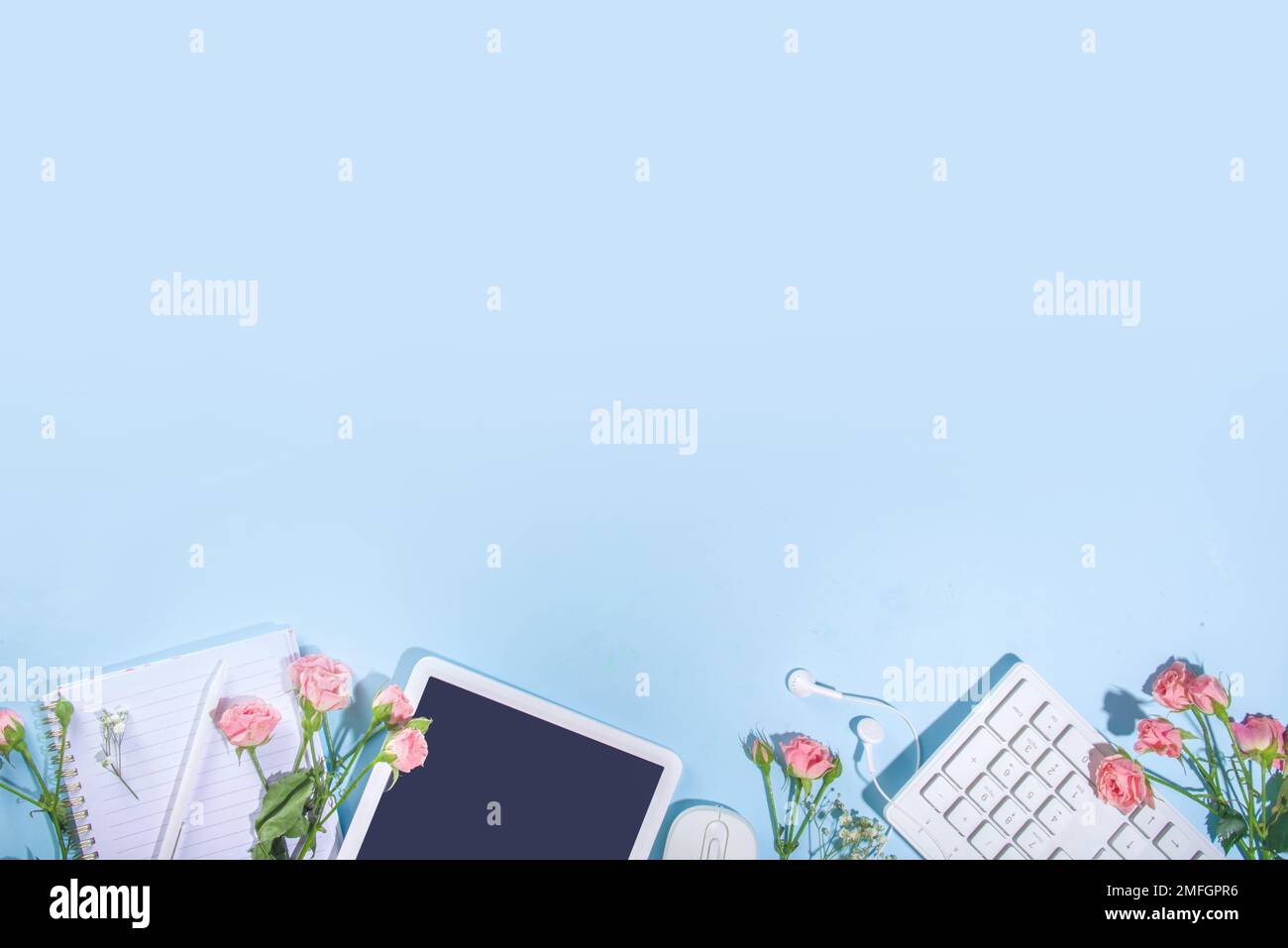 Spring office desk flatlay with keyboard, notepad, tablet, mouse ...