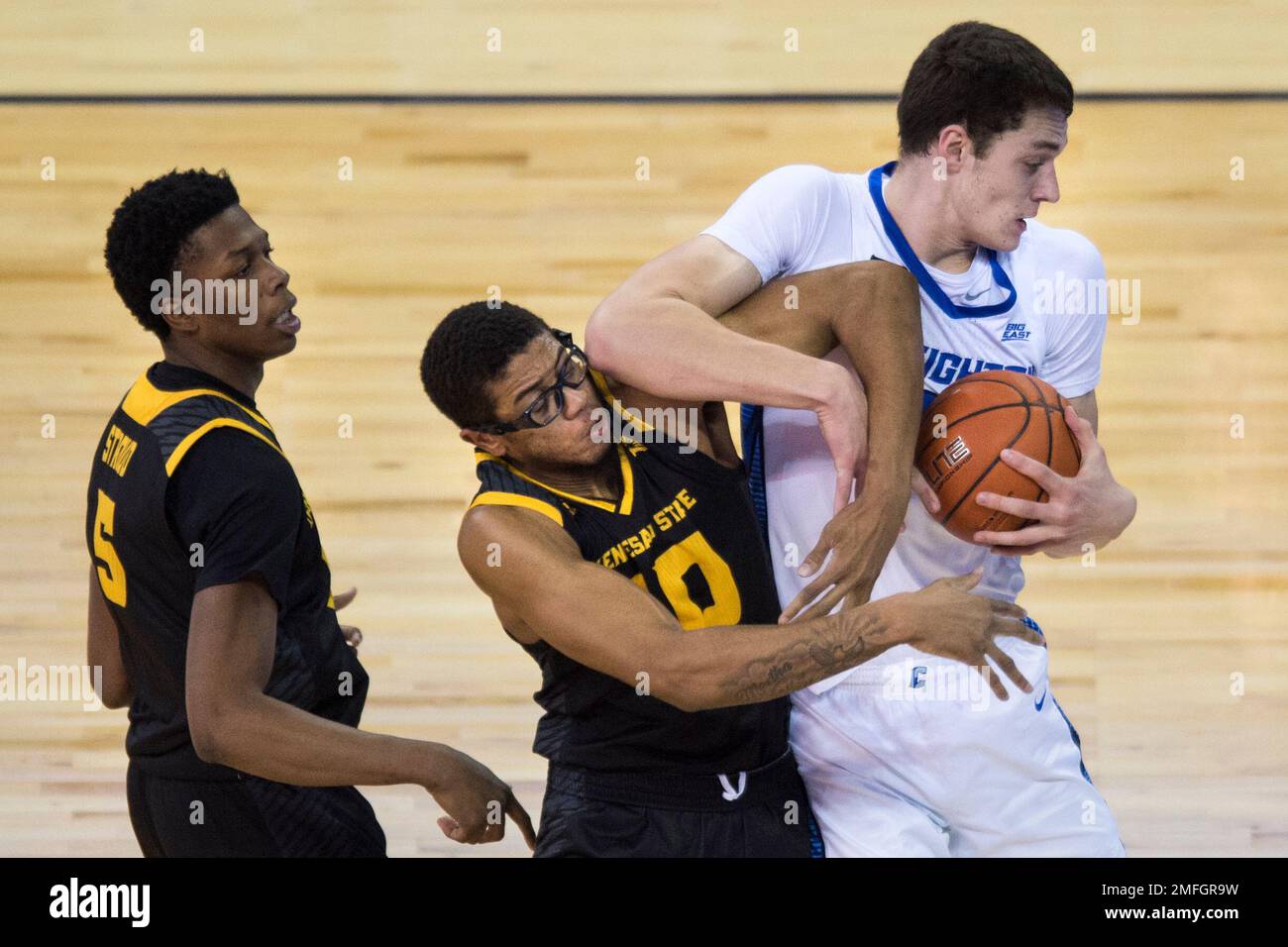 Creighton's Ryan Kalkbrenner pulls in a rebound next to Kennesaw State ...