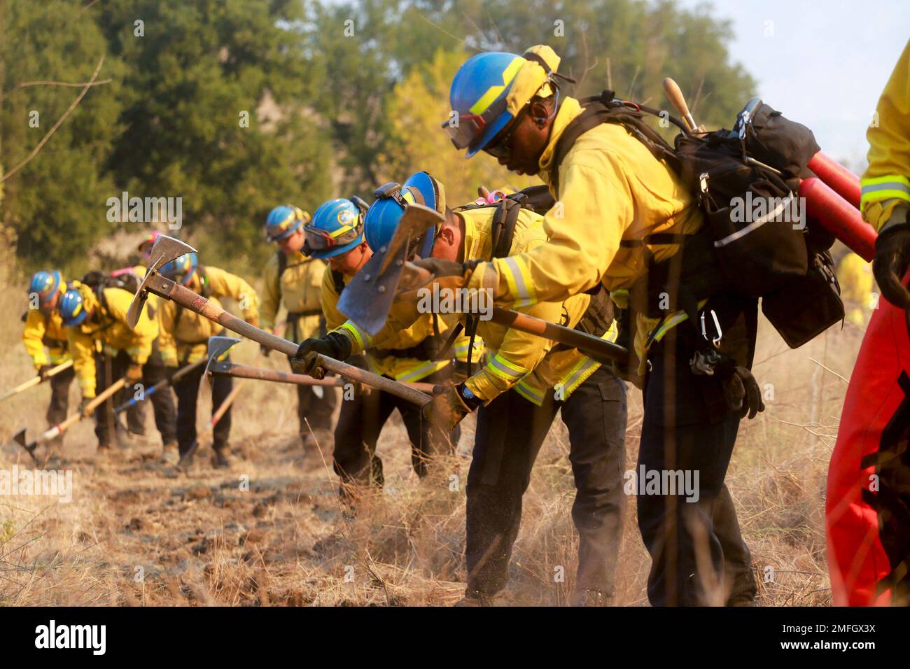 A hotshot hand crew works on a fireline while the Bond Fire burning in ...