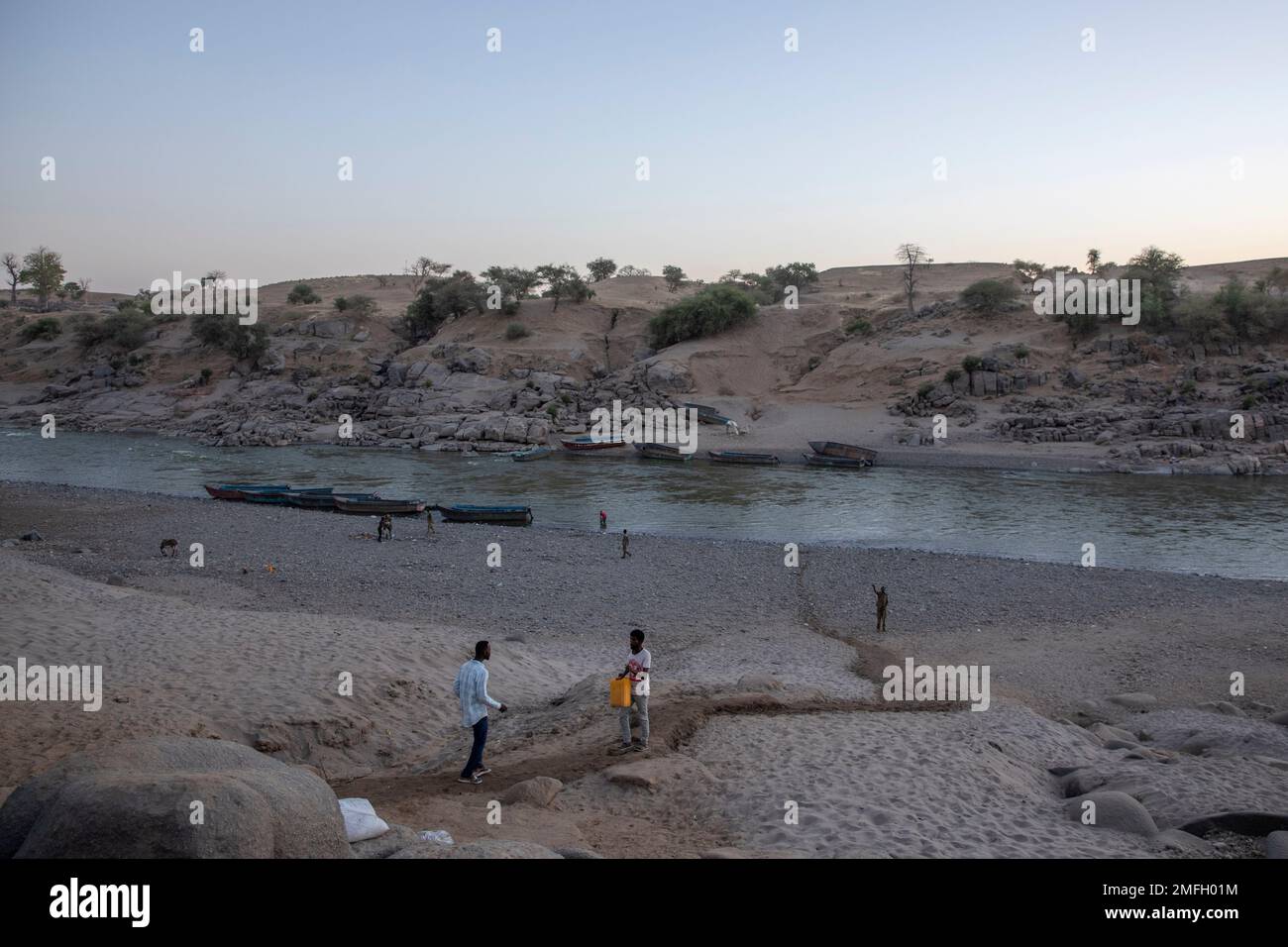 Sudanese forces stand guard and close the crossing after sun set after ...
