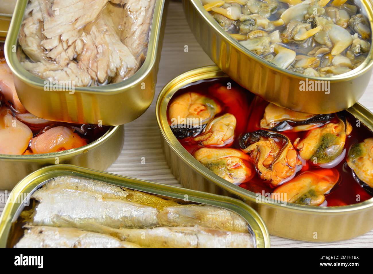 Assortment of cans of canned with different types of fish and seafood ...