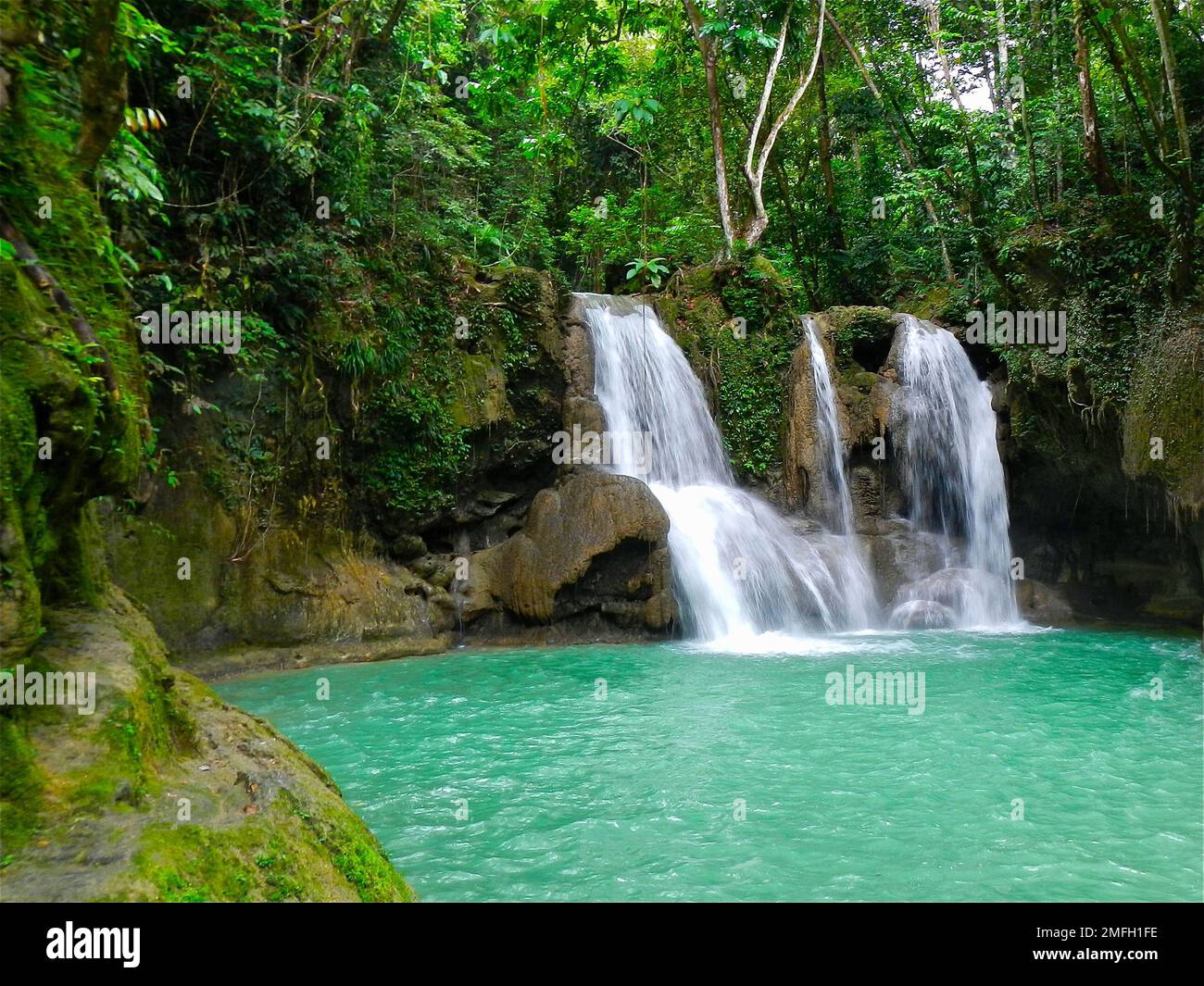 A scenic shot of Magaso falls flowing to a small lake in Bahol ...