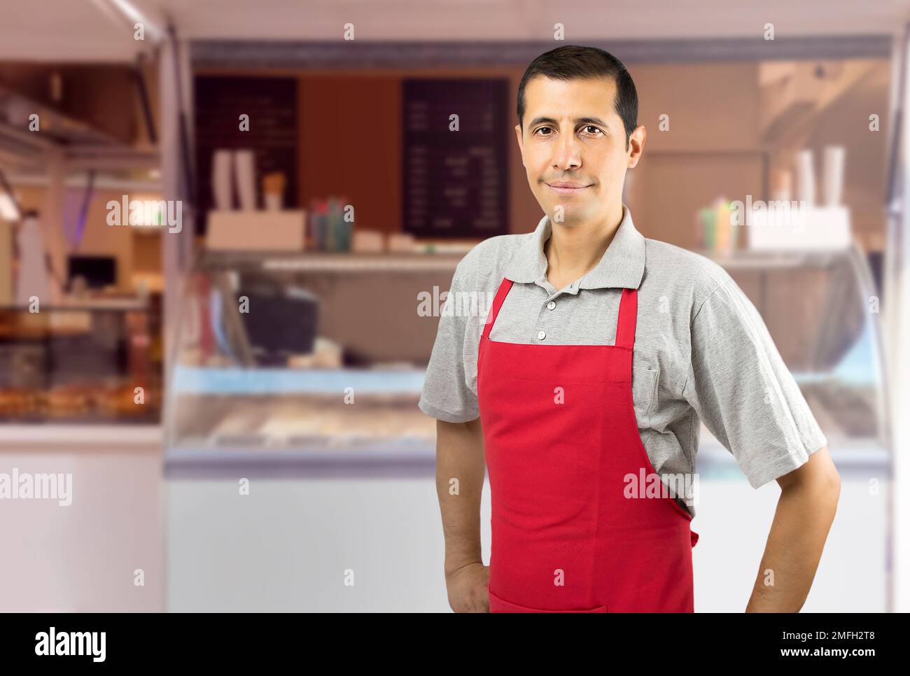 Smiling ice cream car employee with apron at beach Stock Photo - Alamy