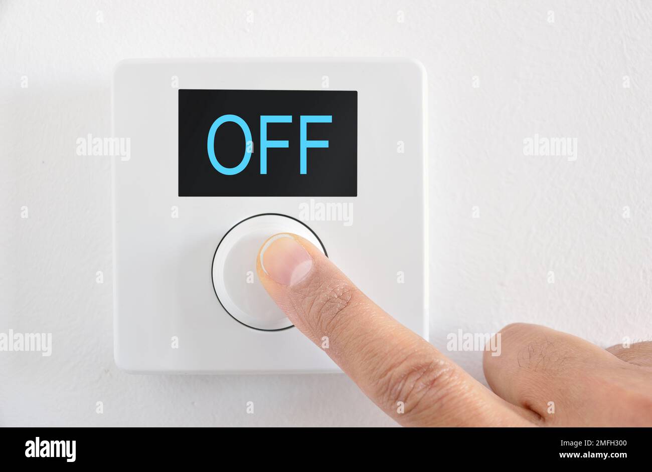 digital thermostat with finger pressing button the off Stock Photo - Alamy