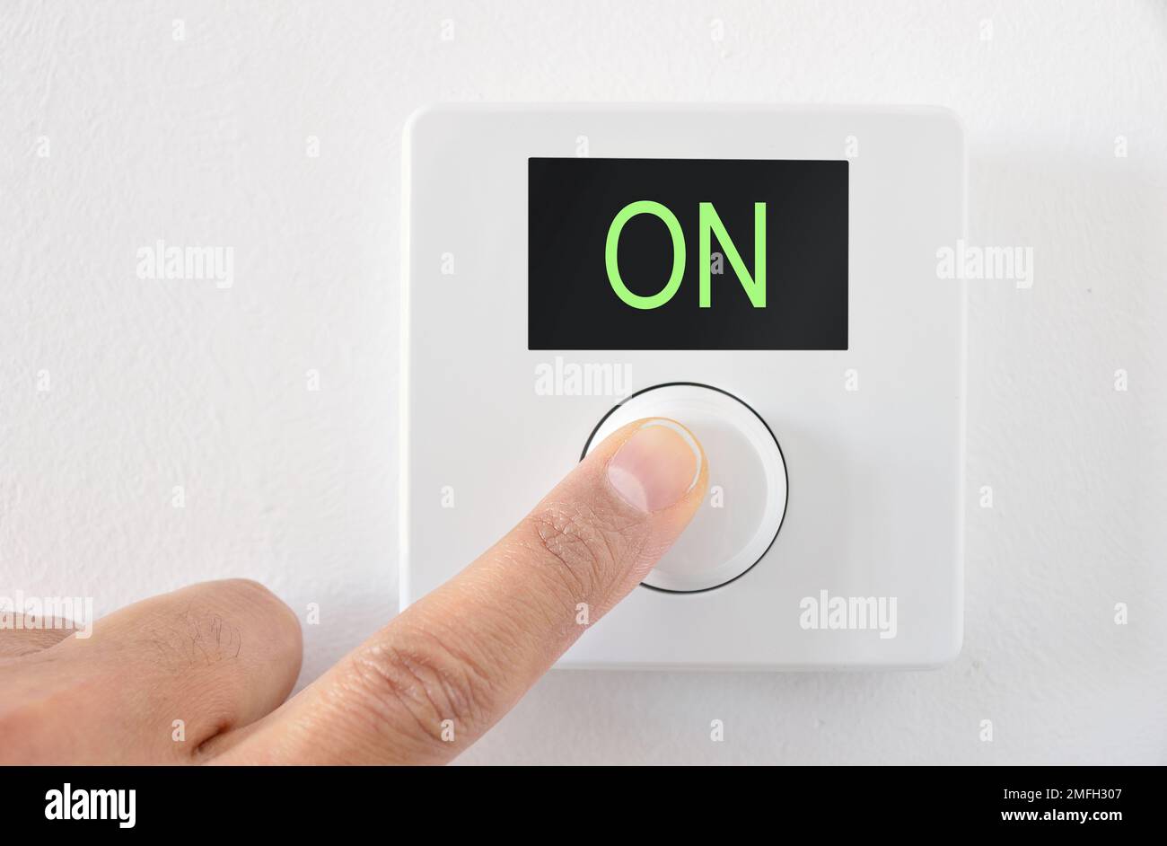 digital thermostat with finger pressing button the On start Stock Photo ...