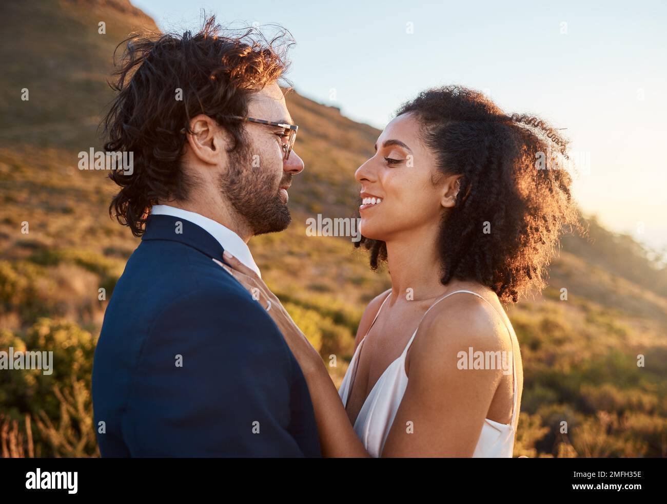 Wedding, trust and bride with groom on mountain for marriage ceremony ...