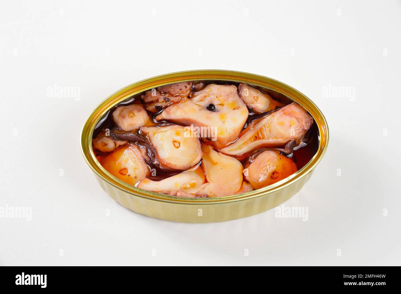 High angle shot of delicious can of preserved octopus in sauce on white ...