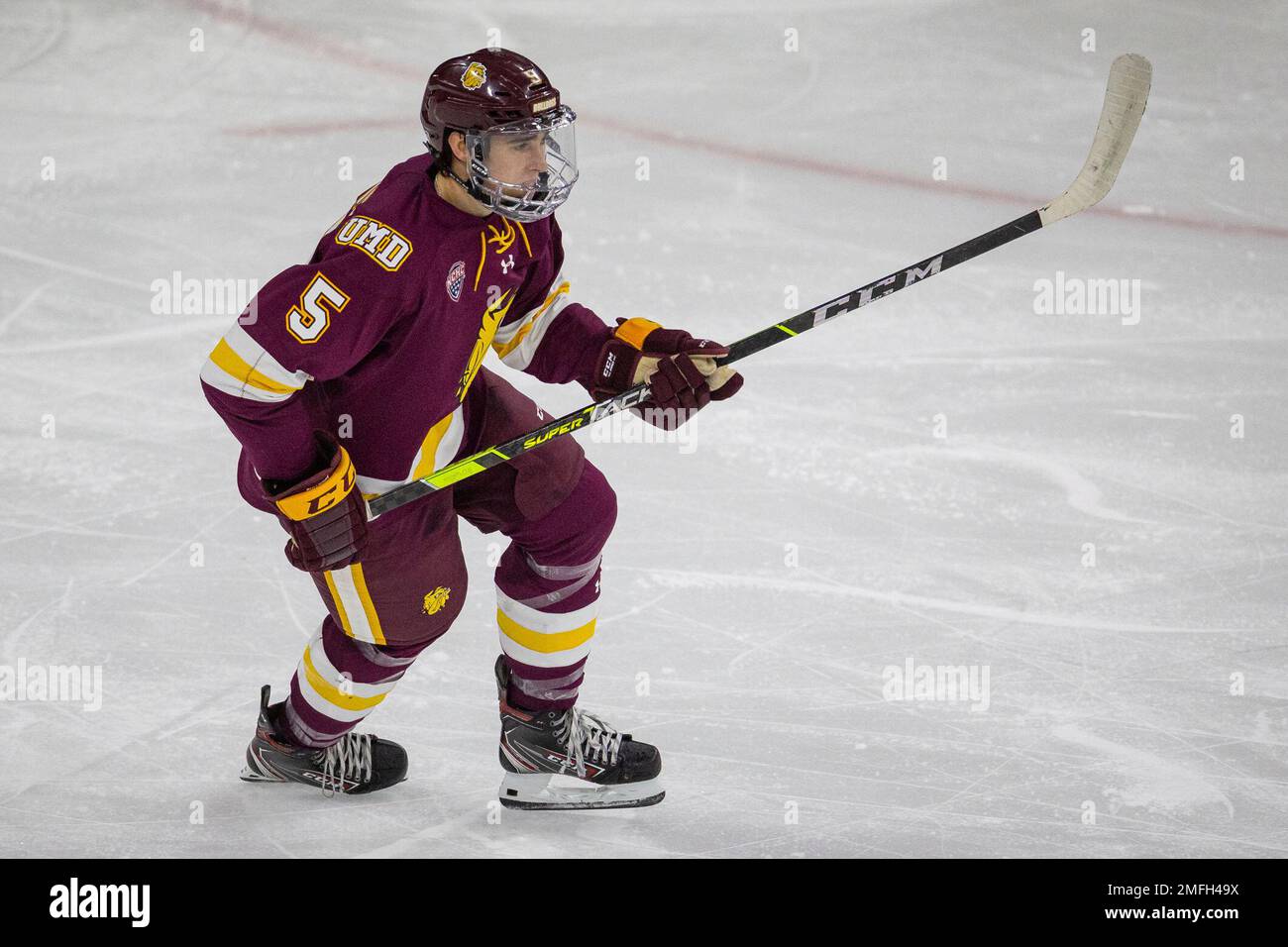 Minnesota-Duluth defenseman Wyatt Kaiser (5) skating down the ice ...