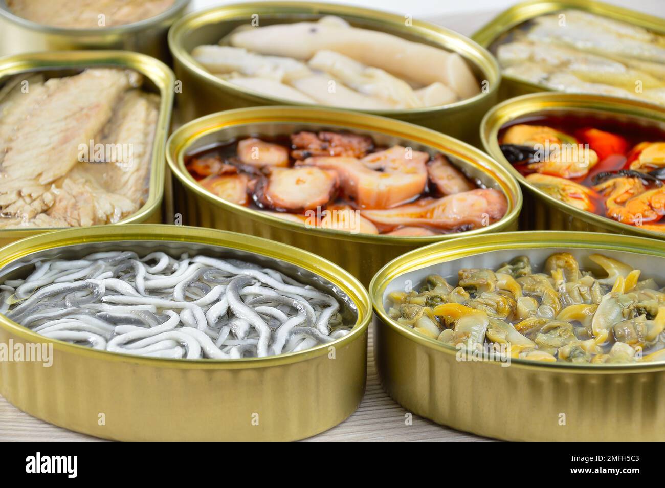 Assortment of cans of canned with different types of fish and seafood ...