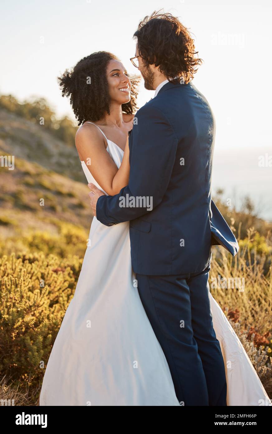Wedding couple, interracial and hug in nature, happy and excited while ...