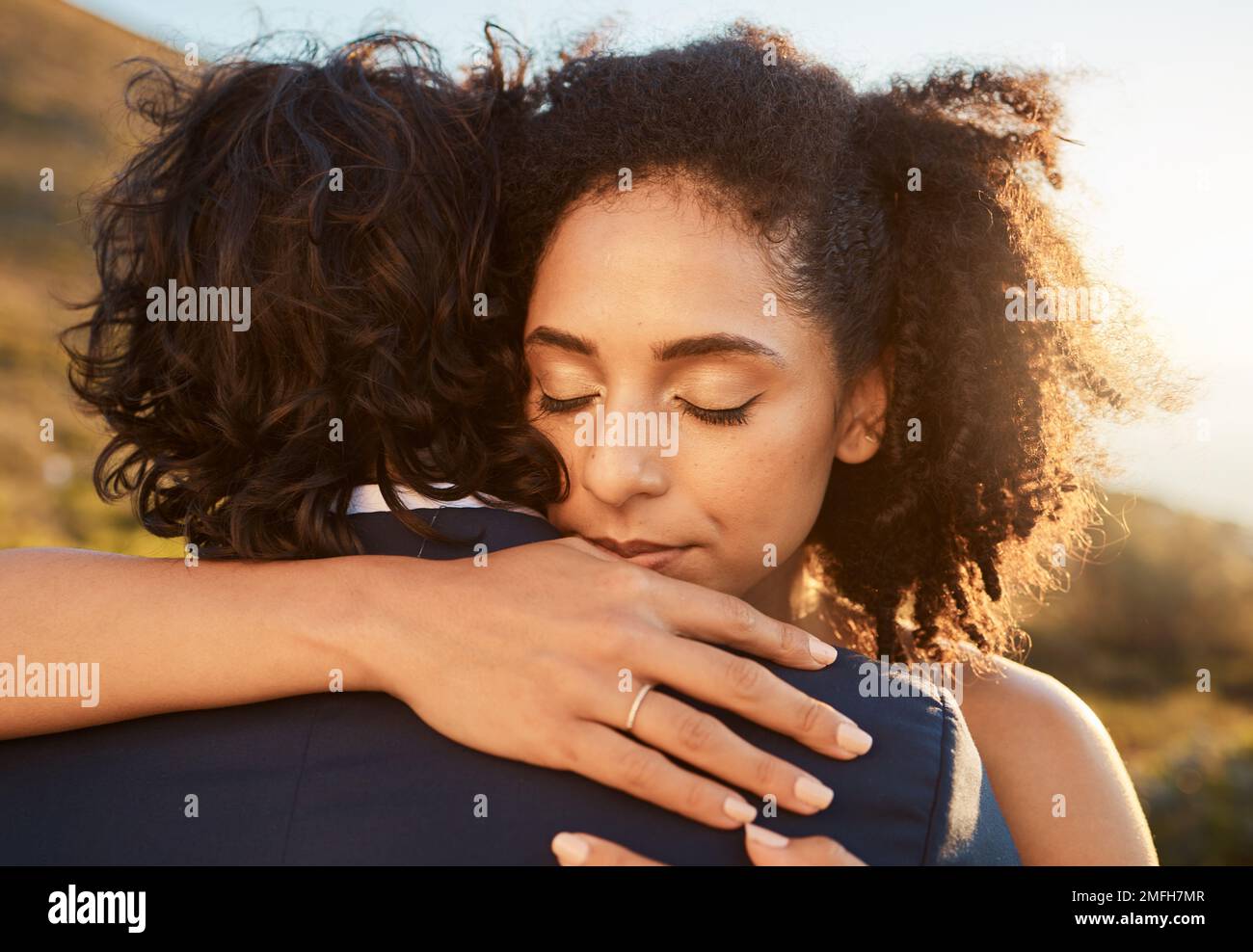 Wedding, black woman and man hug at sunset together for care, love and support for married life ...