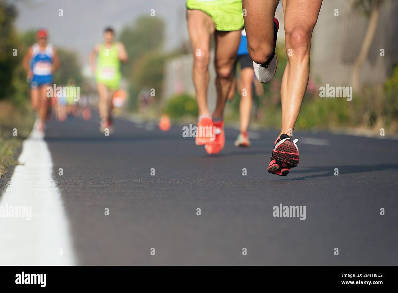 Marathon running race, runners feet on road Stock Photo - Alamy