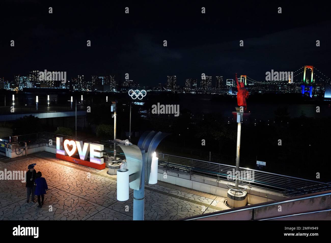 The Olympic rings float in the water with town's landmark "Rainbow ...