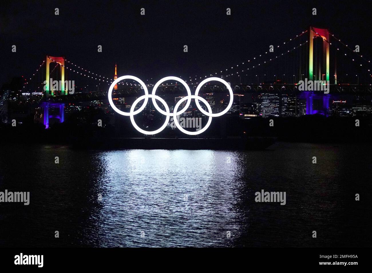 The Olympic rings float in the water with town's landmark "Rainbow ...