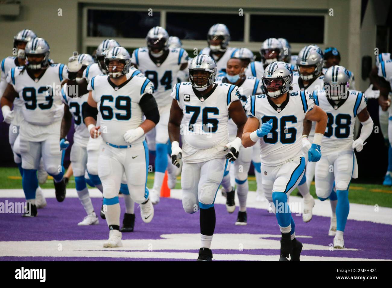 Carolina Panthers players run onto the field before an NFL football ...
